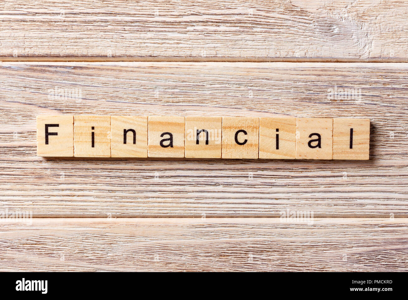 financial word written on wood block. financial text on table, concept ...