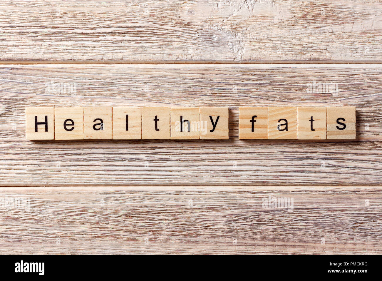 Healthy fats word written on wood block. Healthy fats text on table ...