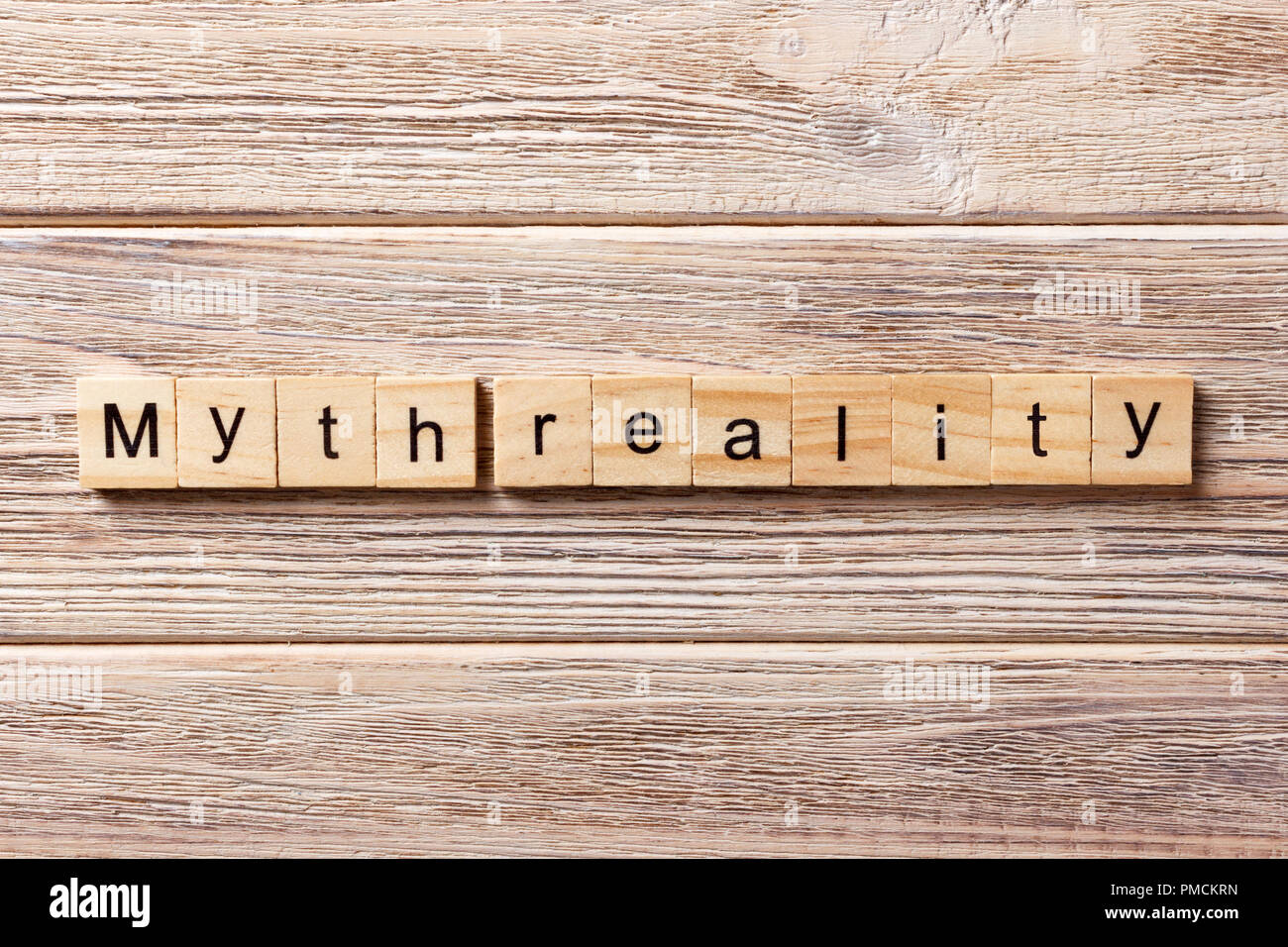 Myth reality word written on wood block. Myth reality text on table ...