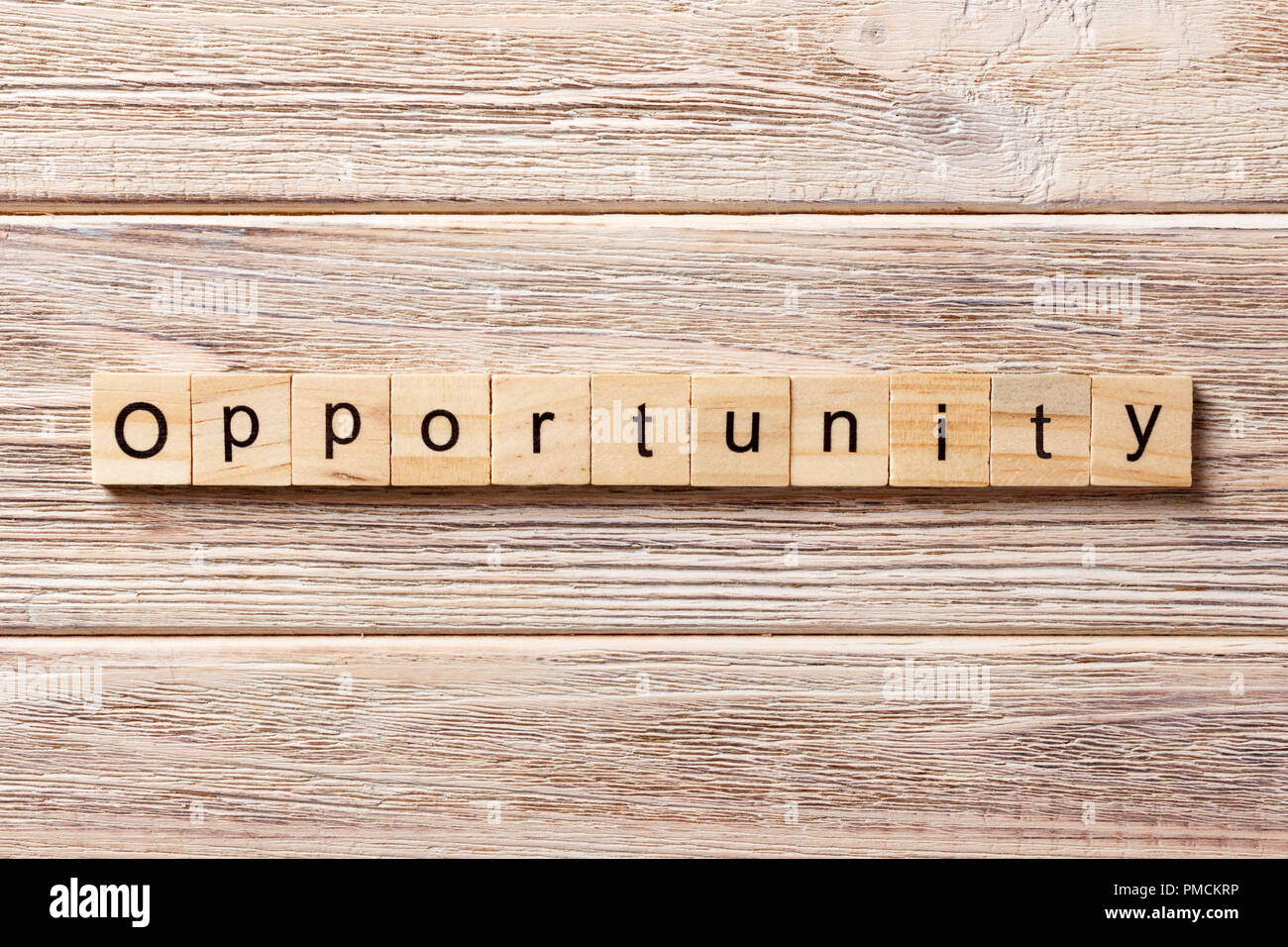 Opportunity word written on wood block. Opportunity text on table ...