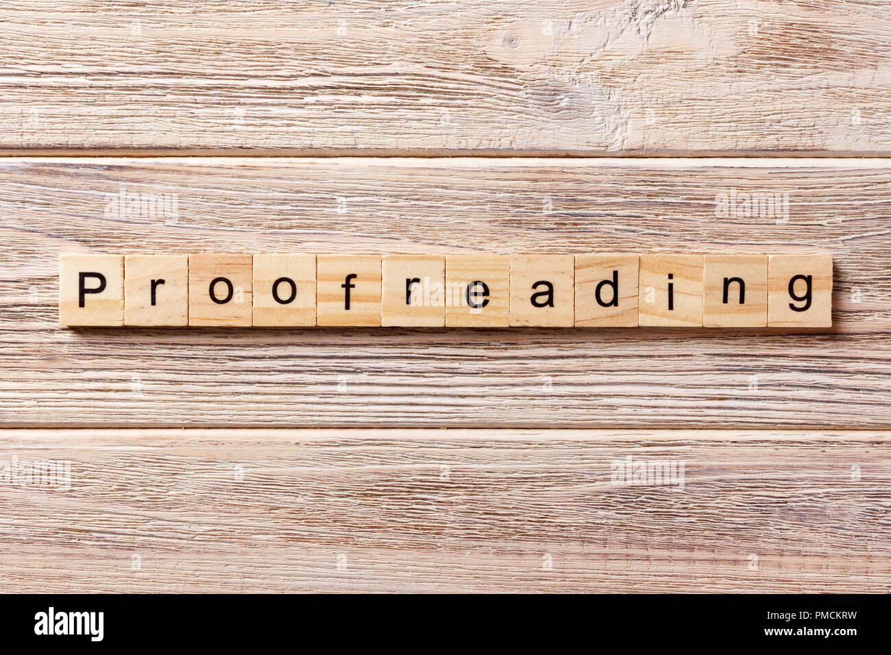 proofreading word written on wood block. proofreading text on table ...