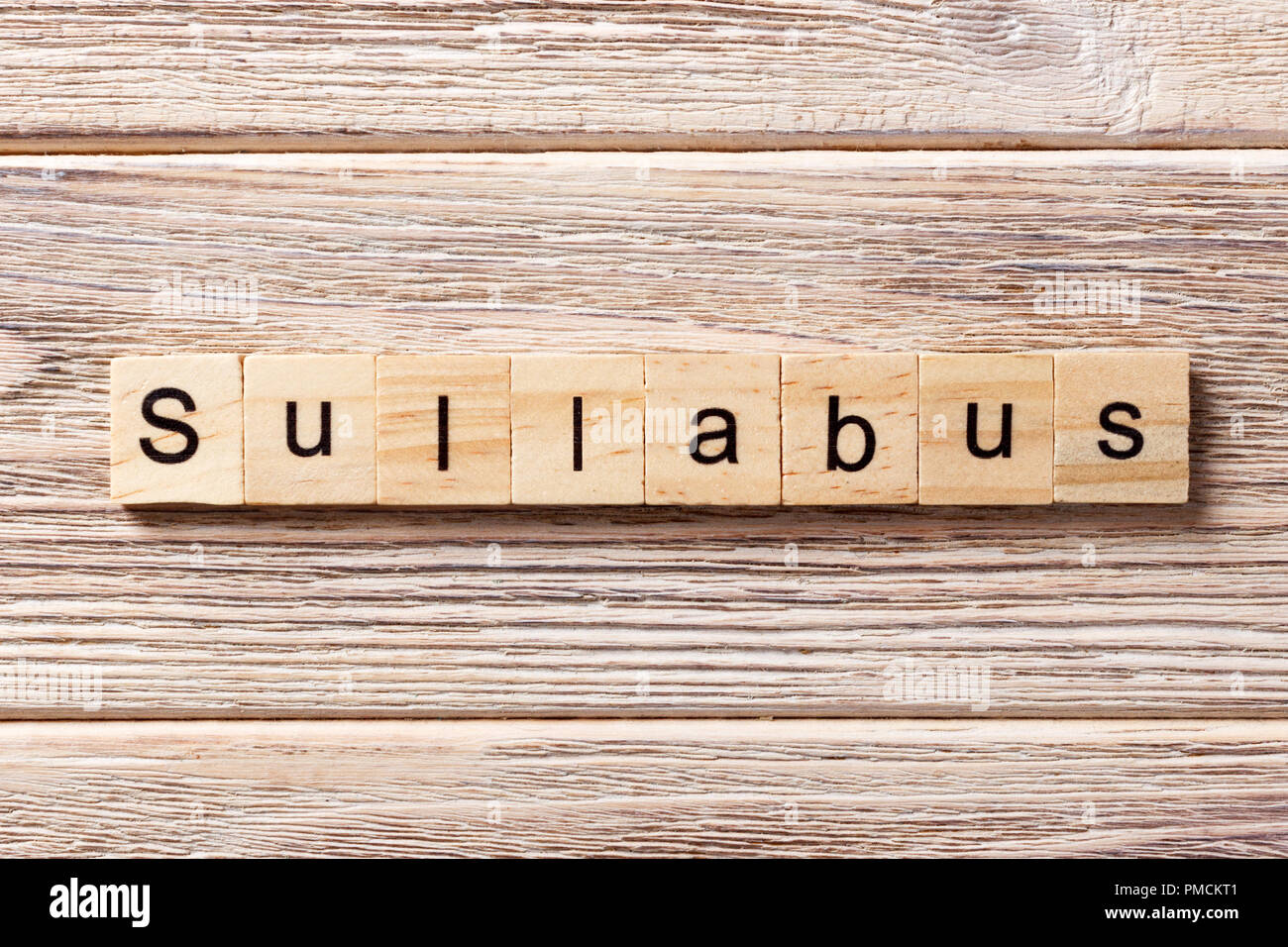 SYLLABUS word written on wood block. SYLLABUS text on table, concept ...