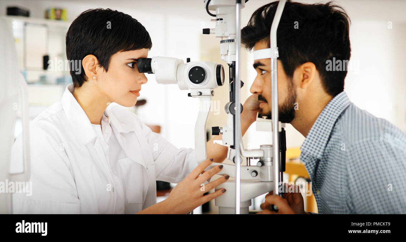 Optometrist examining patient in modern ophthalmology clinic Stock ...