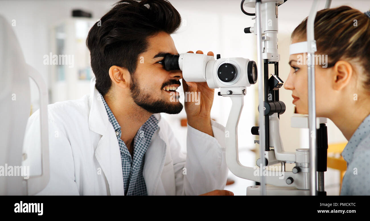 optometrist checking patient eyesight and vision correction Stock Photo ...
