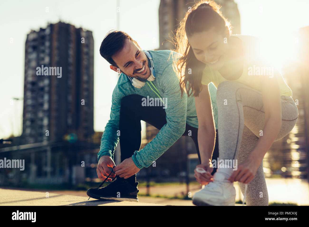 Runners tying running shoes and getting ready to run Stock Photo - Alamy