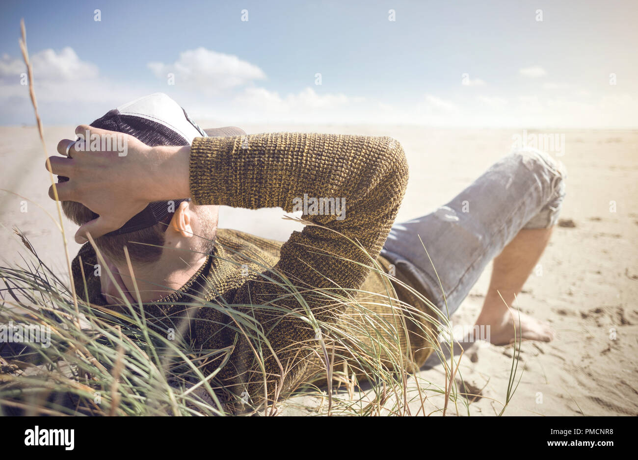 Man lying on a beach at the North Sea Stock Photo - Alamy
