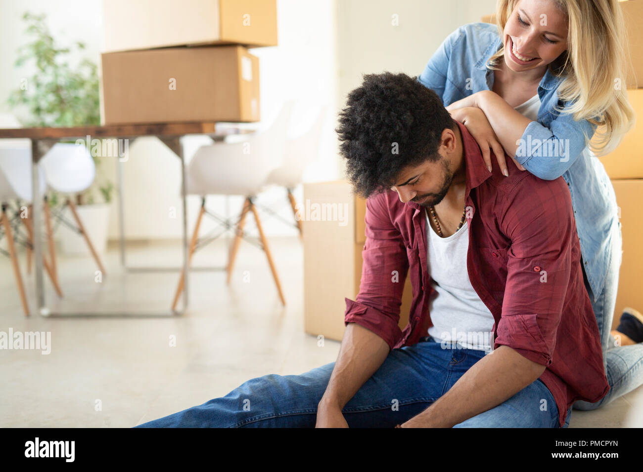 Tired couple with boxes moving into new home Stock Photo - Alamy
