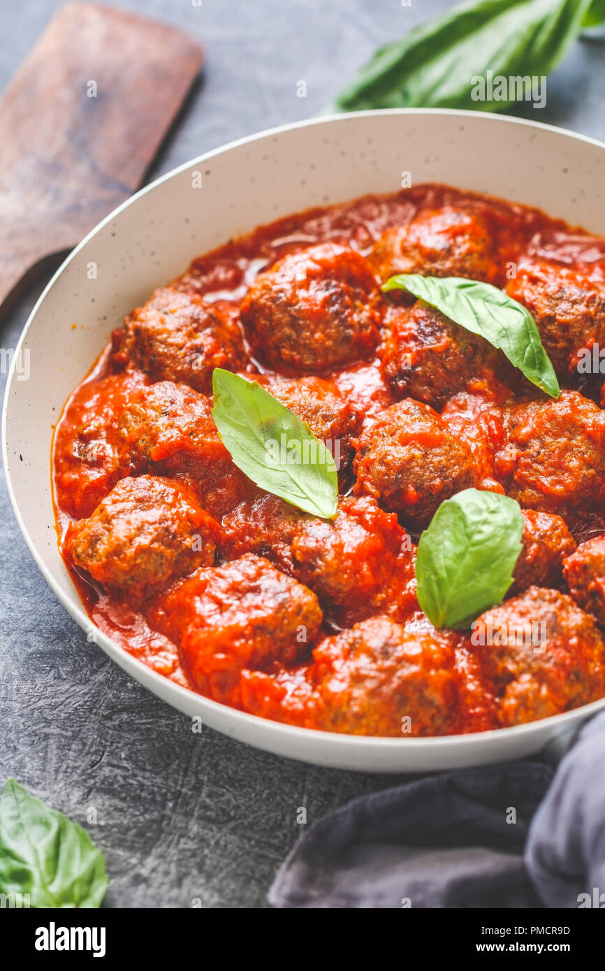 Tasty beef meatballs in tomato sauce with spices and fresh basil on a ...