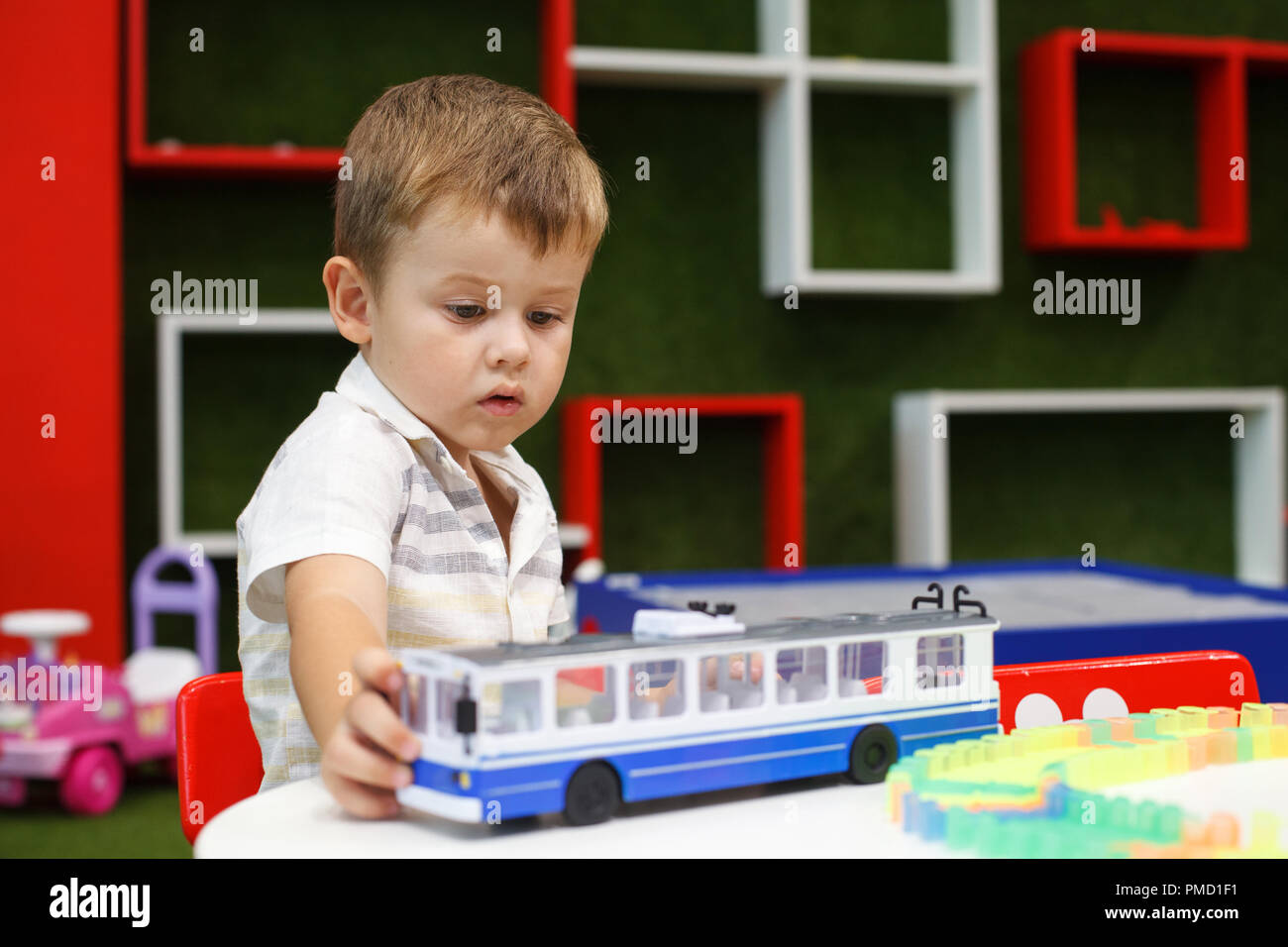 Cute boy playing with trolley car. Developing toys. Transportation toys ...