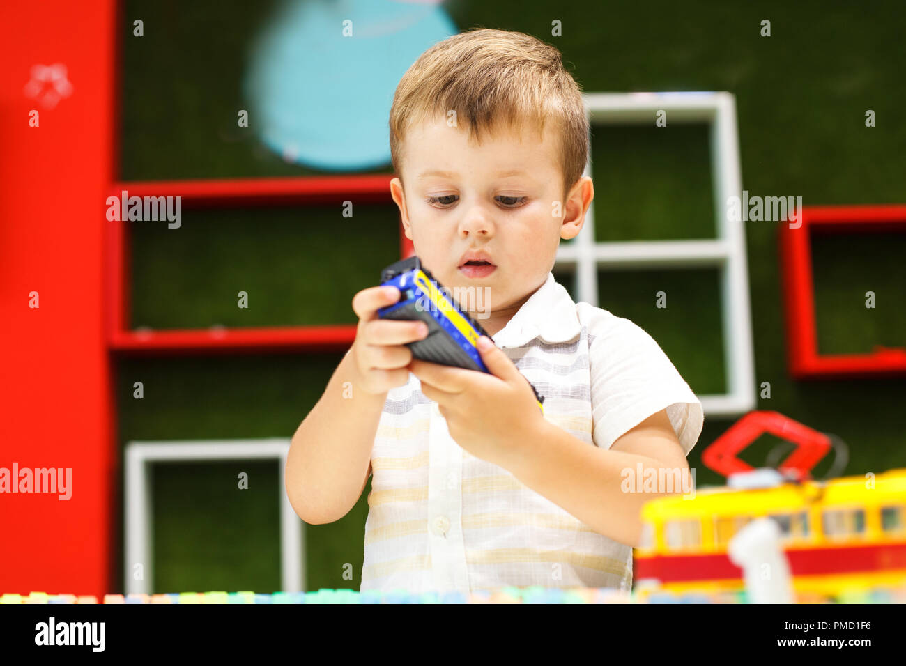 Cute boy playing with tram. Developing toys. Transportation toys for ...