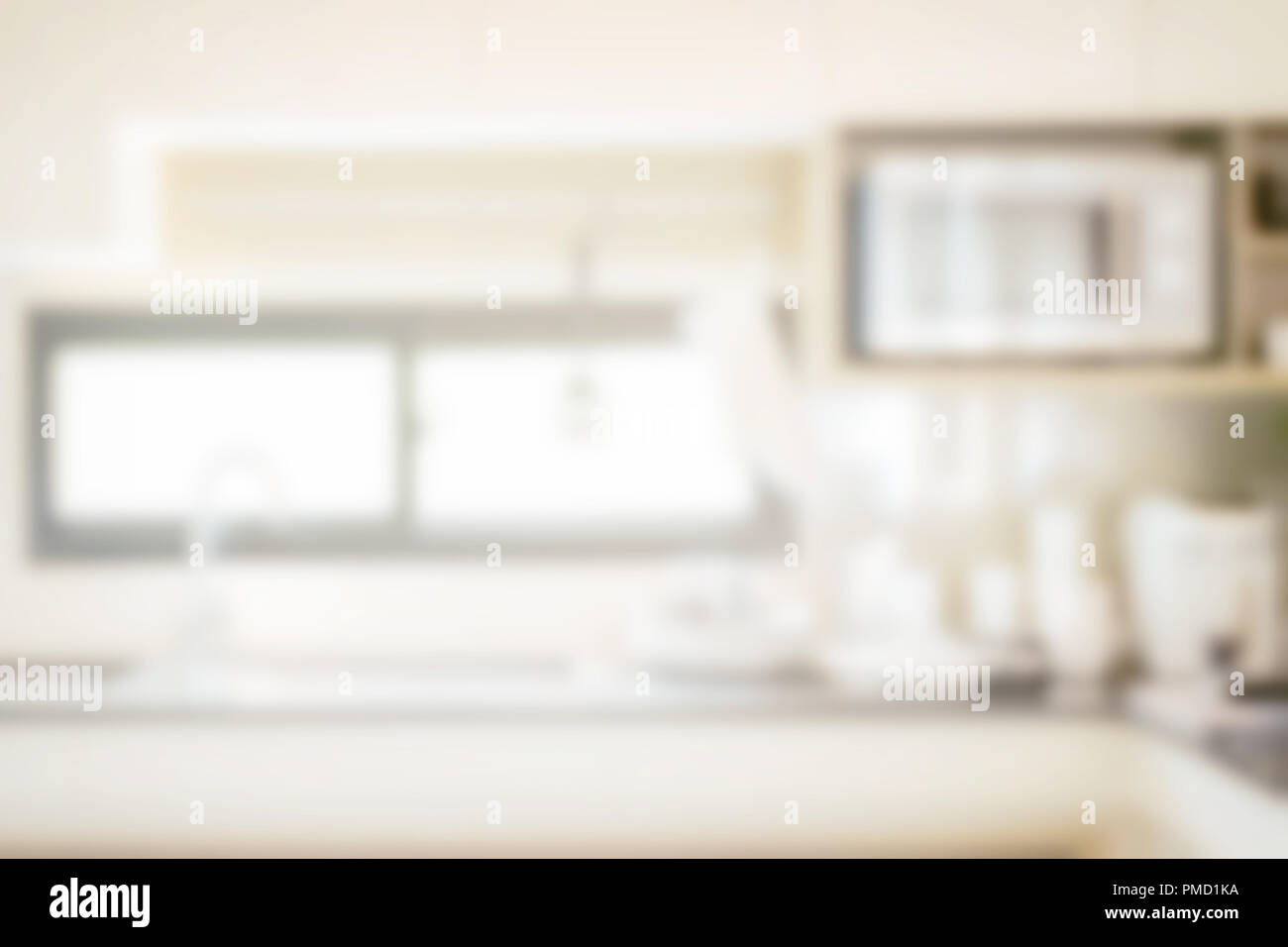 blurred modern kitchen with ceramic ware and utensils setting up next ...