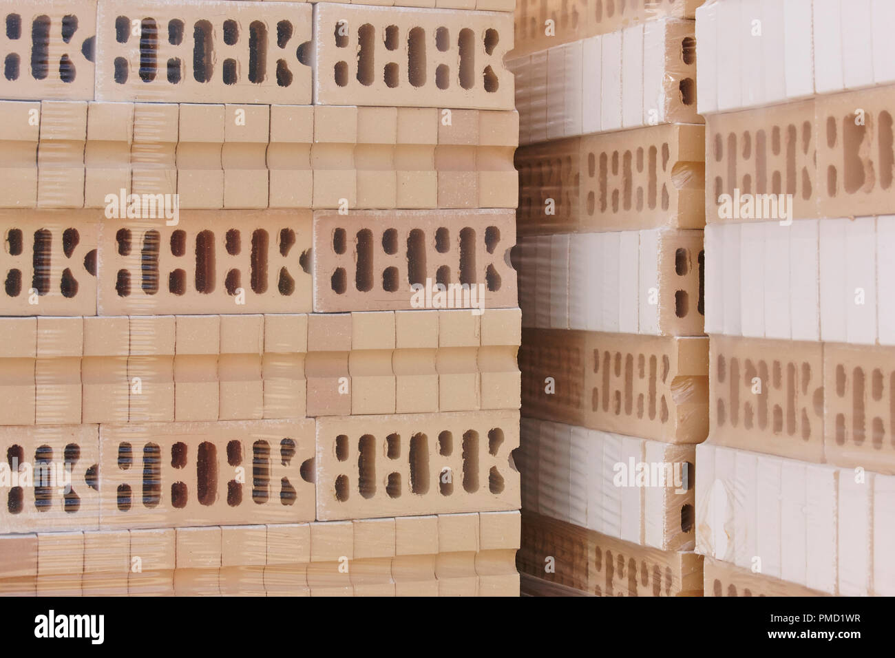 Packed and stacked bricks. Construction industry. Building pieces ...