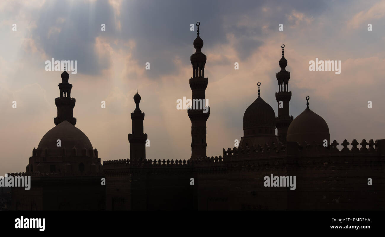 Silhouette shot of minarets and domes of Sultan Hasan mosque and Al Rifai Mosque, Old Cairo ...
