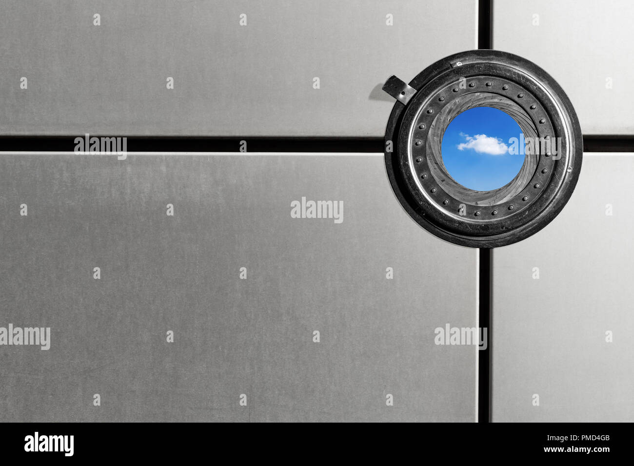 An round aperture in an metal paneling shows blue sky, horizontal Stock ...