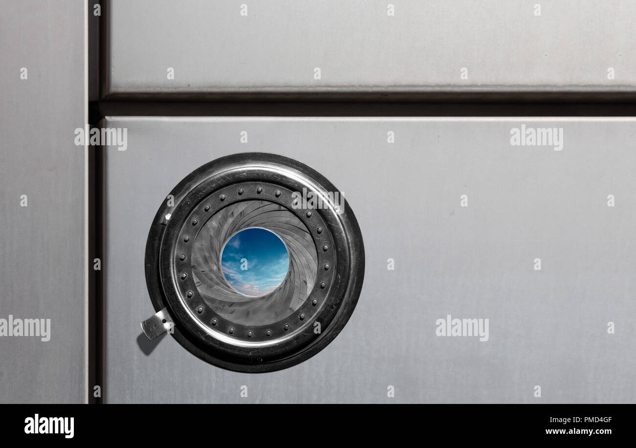 An round aperture in an metal paneling shows night sky, horizontal ...