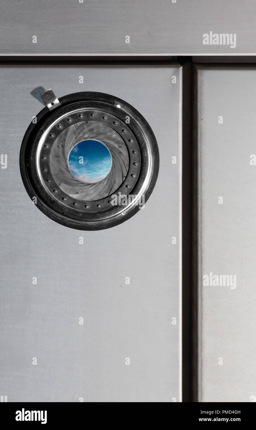 An round aperture in an metal paneling shows night sky, vertical Stock ...
