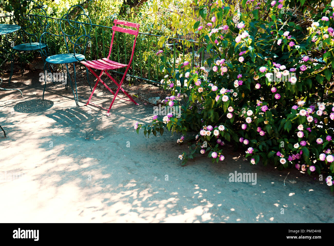 Simple metal chairs in a relaxing park in Corsica Stock Photo - Alamy