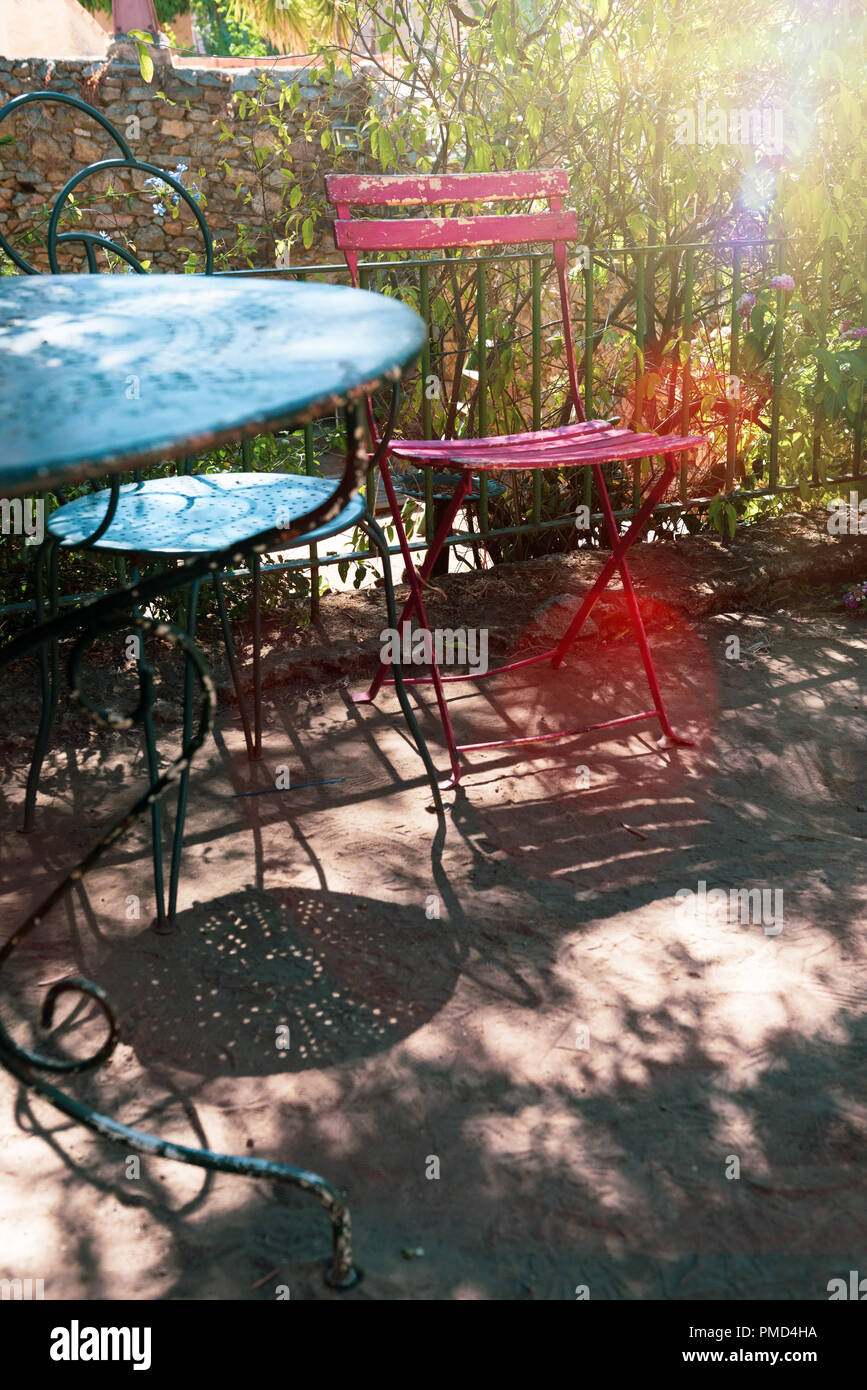 Simple metal chairs in a relaxing park in Corsica Stock Photo - Alamy