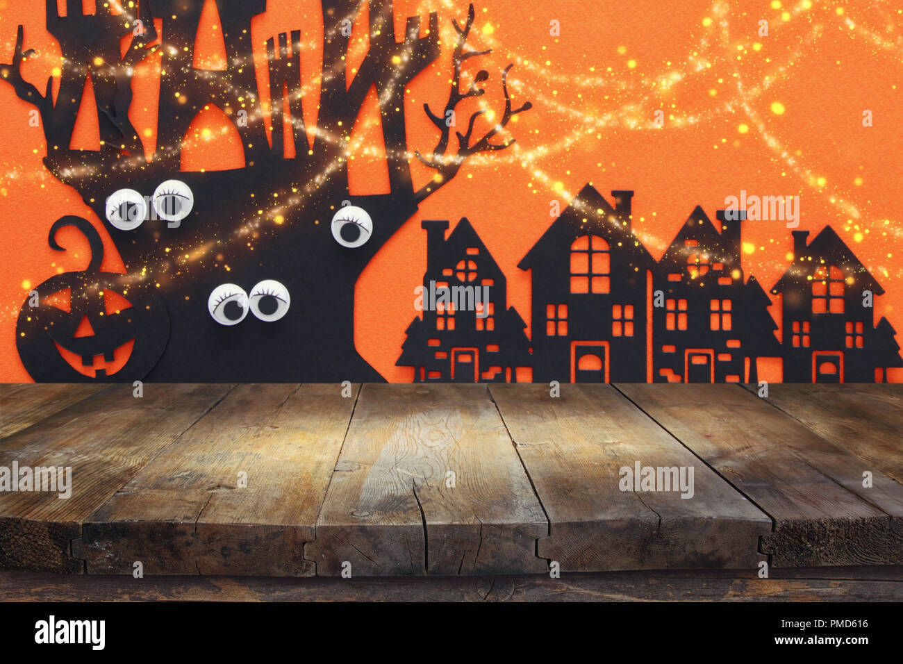 Halloween holiday concept. Empty rustic table in front of haunted ...