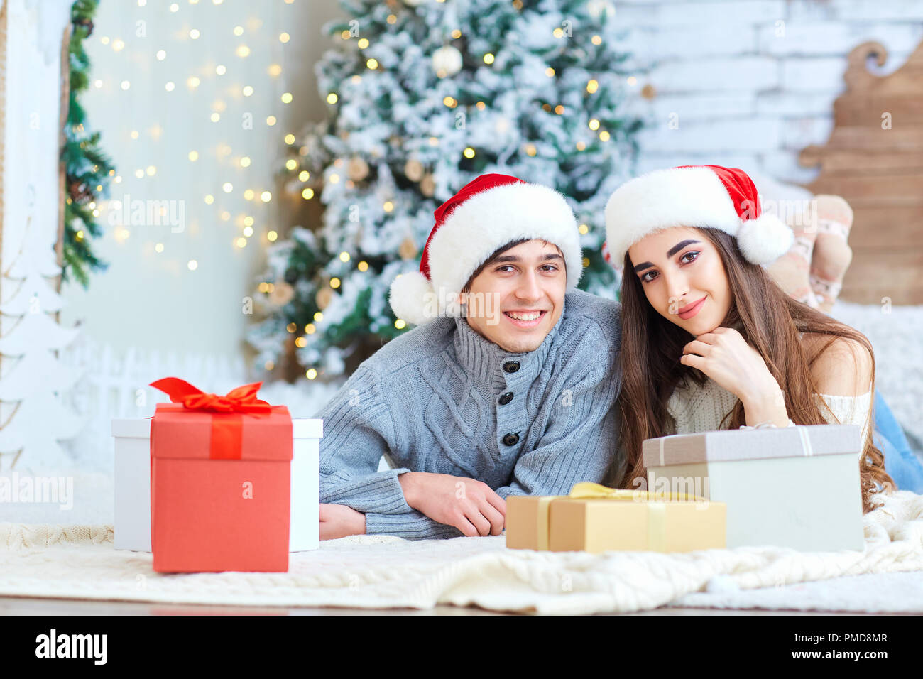 Happy young couple having fun at Christmas Stock Photo - Alamy