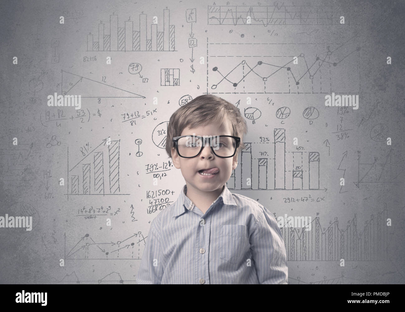Little boy in front of a grey wall with graphs and statistics around ...