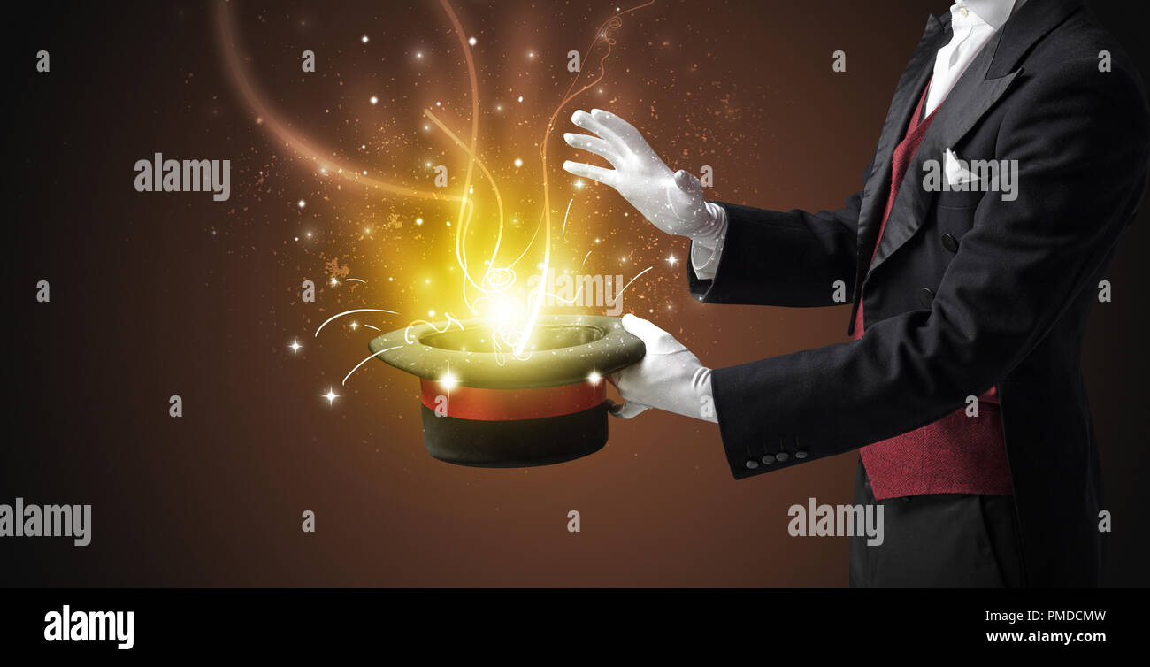 Magician hand conjure with wand light from a black cylinder Stock Photo ...