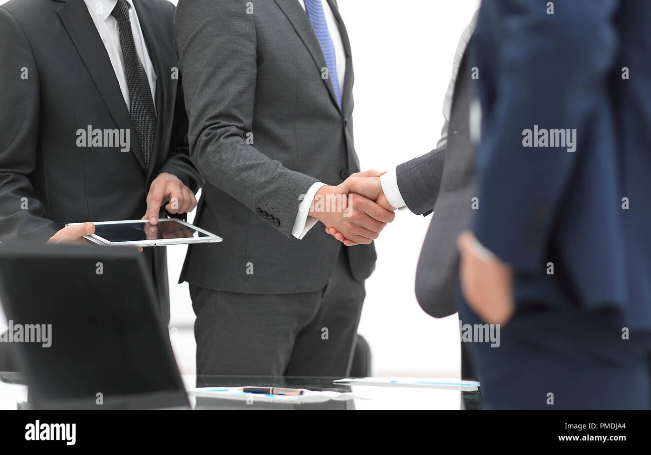 Business partners handshaking with their colleagues Stock Photo - Alamy