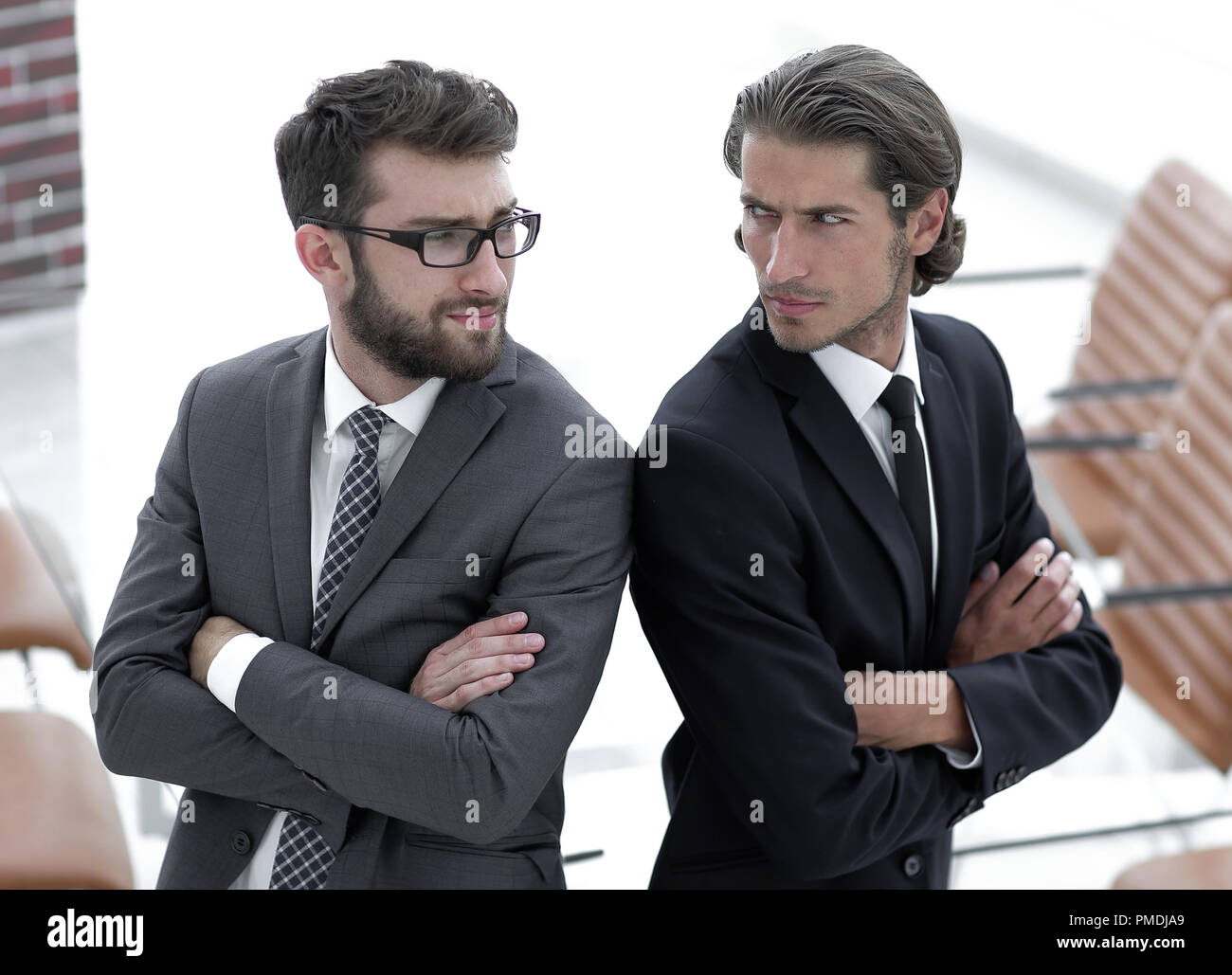 Two men standing back to back and support each other Stock Photo - Alamy