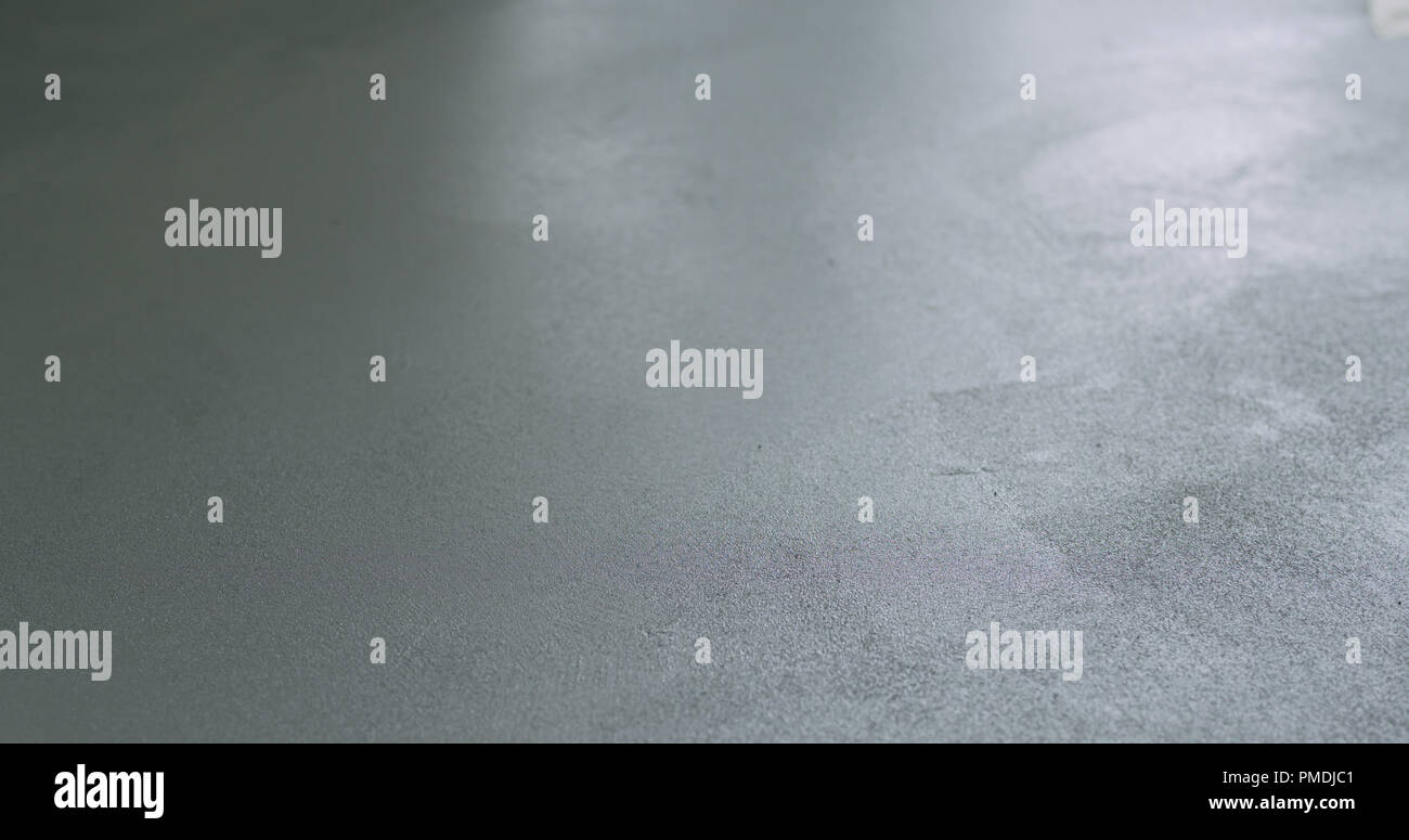 closeup applying micro concrete plaster coating on the floor, wide ...