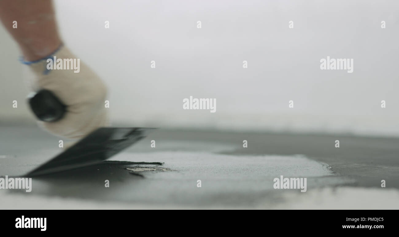 closeup male worker applying micro concrete plaster coating on the ...