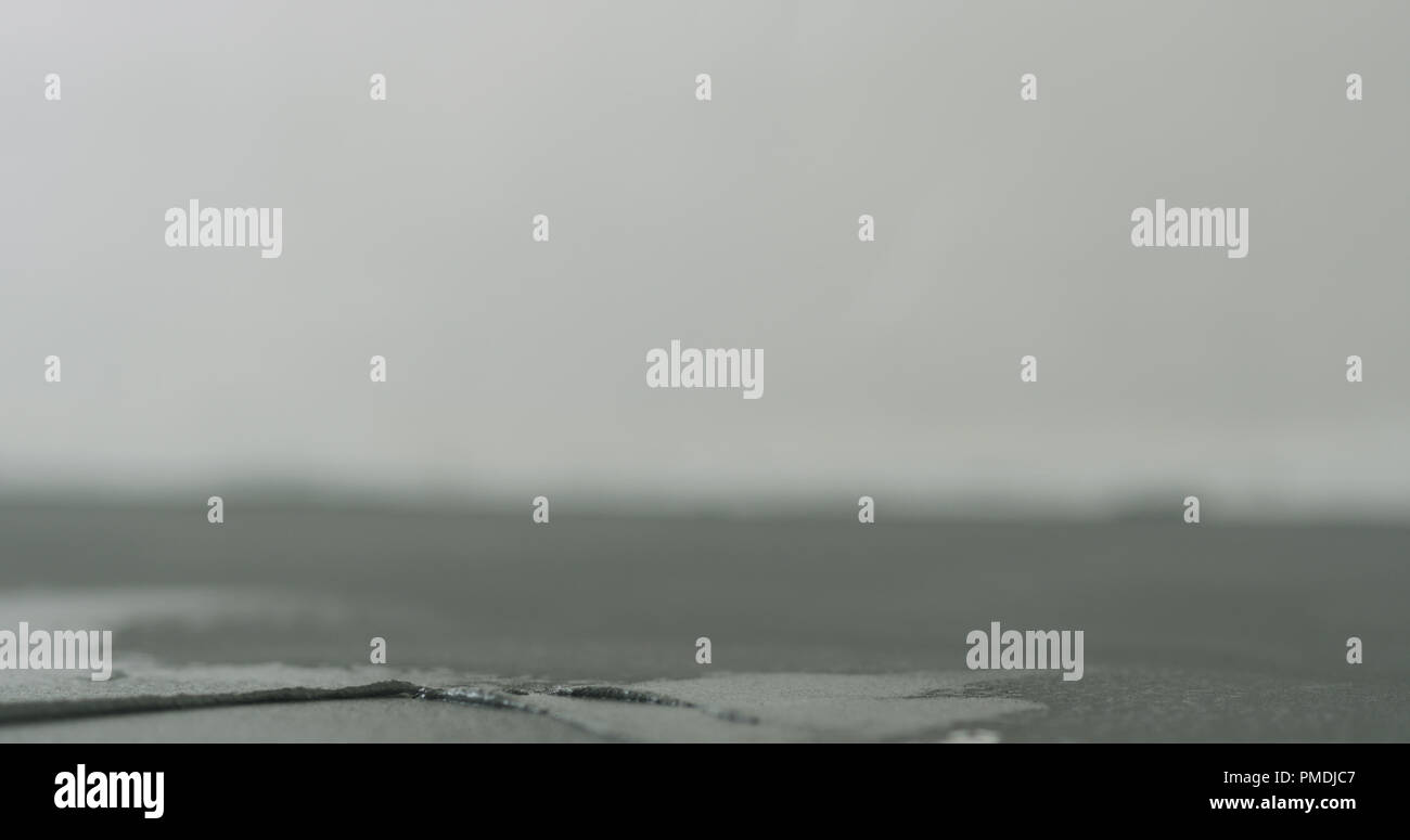 closeup applying micro concrete plaster coating on the floor, wide ...