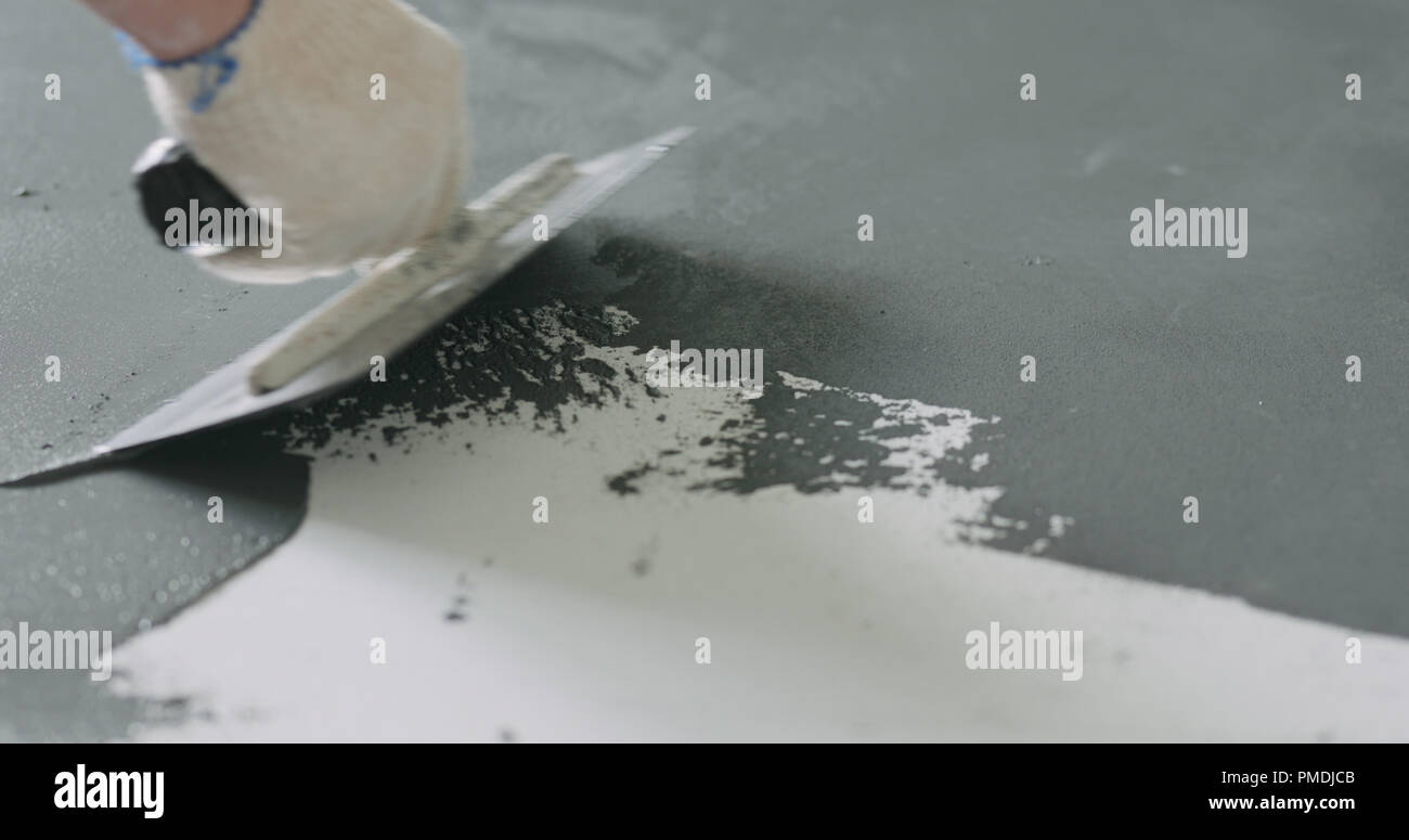 closeup male worker applying micro concrete plaster coating on the ...