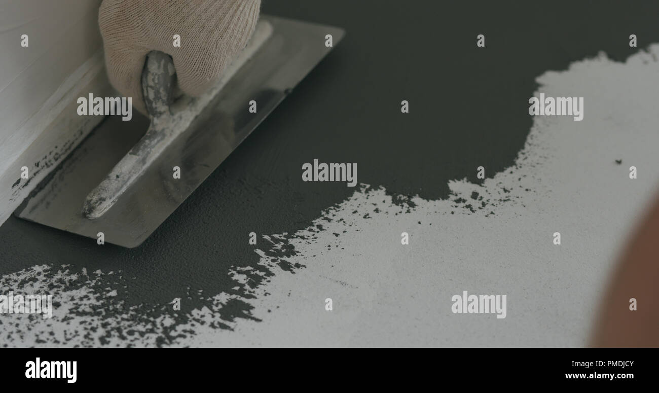 closeup male worker applying micro concrete plaster coating on the ...