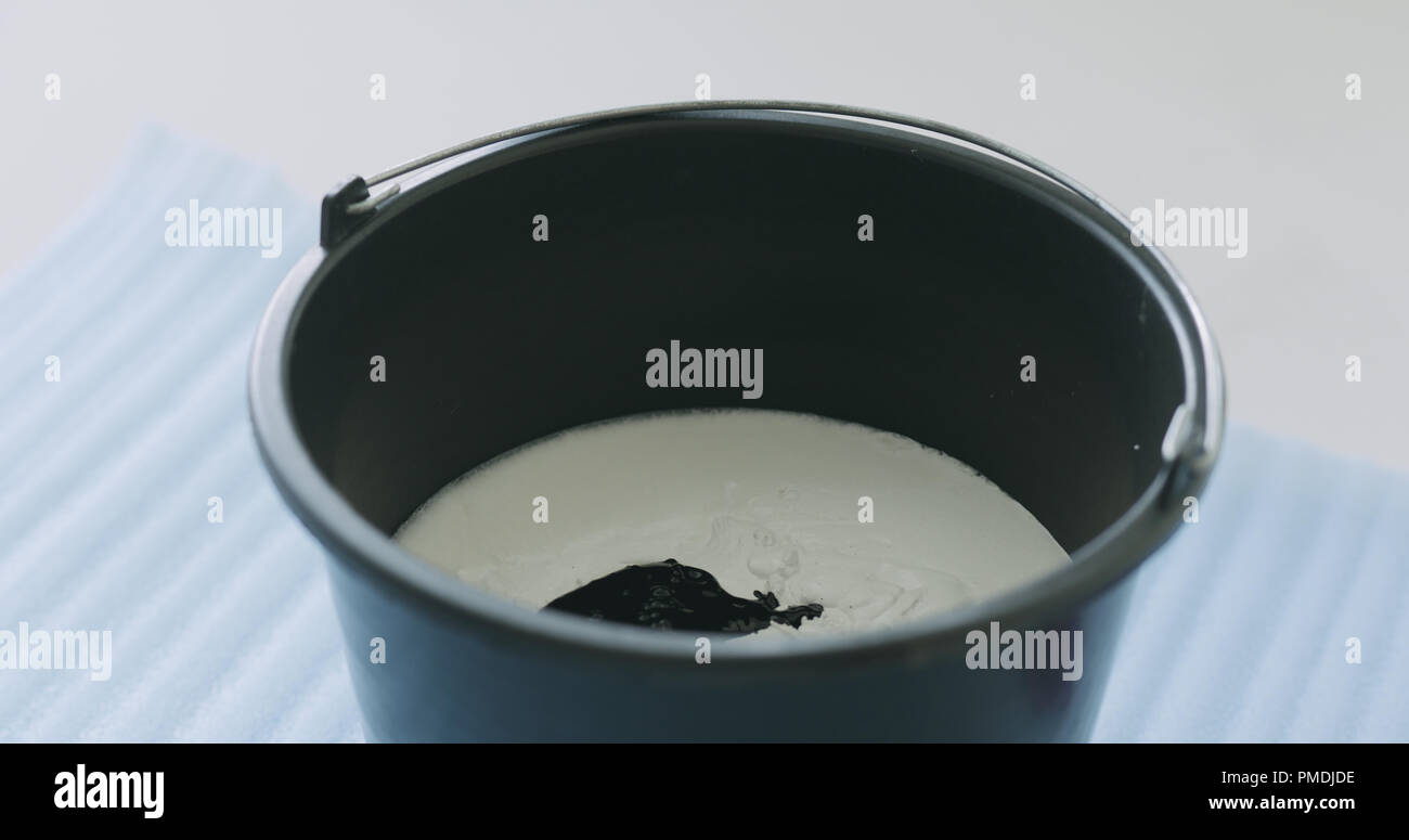 adding black ink to micro concrete plaster Stock Photo - Alamy