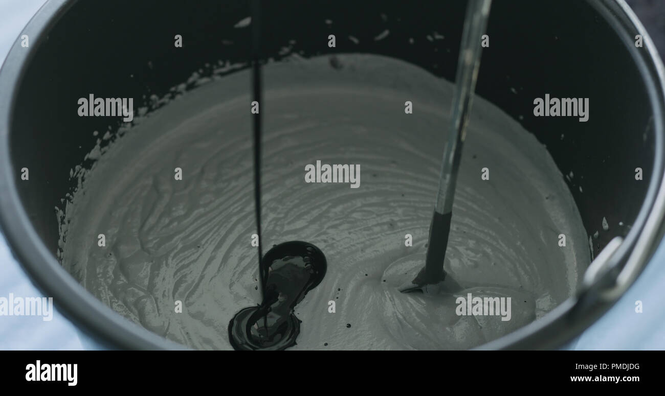 adding black ink to micro concrete plaster Stock Photo - Alamy