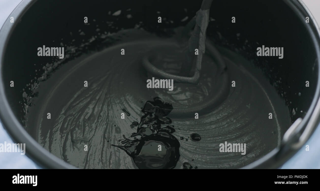 adding black ink to micro concrete plaster Stock Photo - Alamy