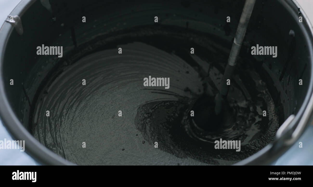 adding black ink to micro concrete plaster Stock Photo - Alamy