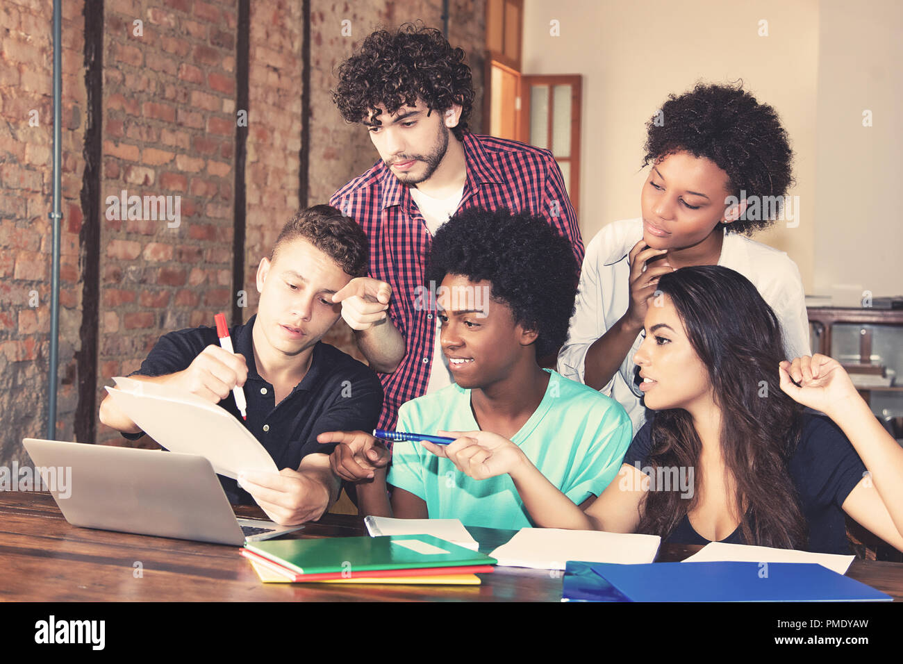 Group of international students in discussion at university Stock Photo ...
