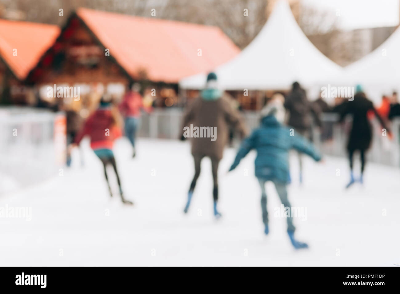 Blurred background people ride on an open skating rink on ...