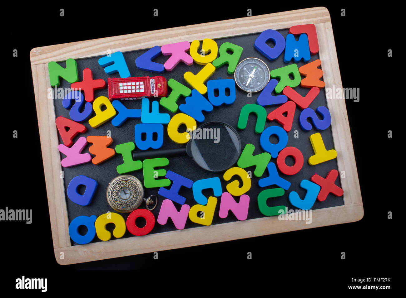 Magnifying glass and Colorful Letters of Alphabet Stock Photo - Alamy