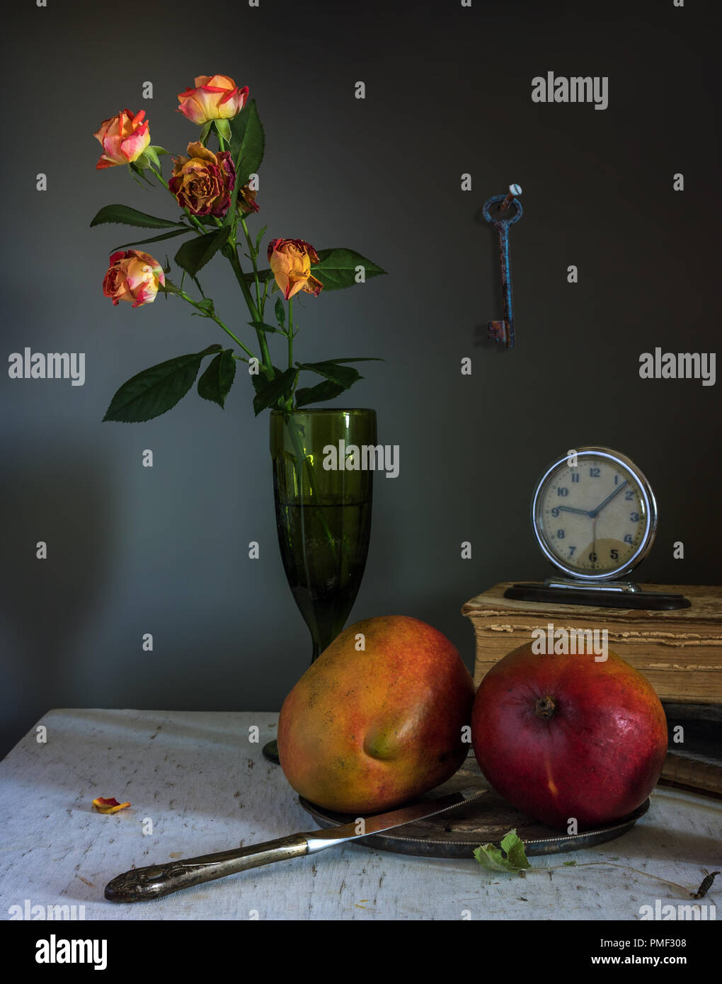 still life with mango fruits, books and a bunch of roses. vintage Stock ...