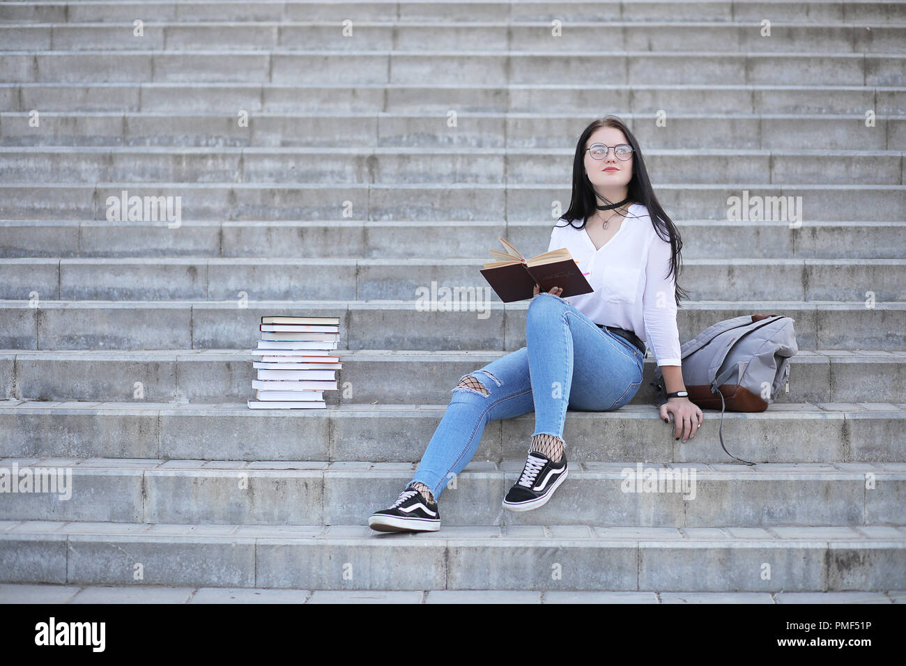Girl student on the street with books Stock Photo - Alamy