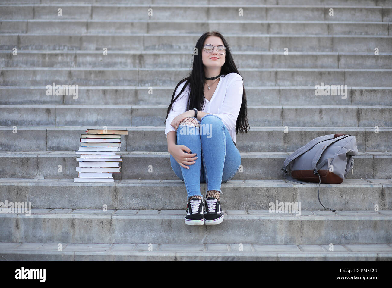 Girl student on the street with books Stock Photo - Alamy