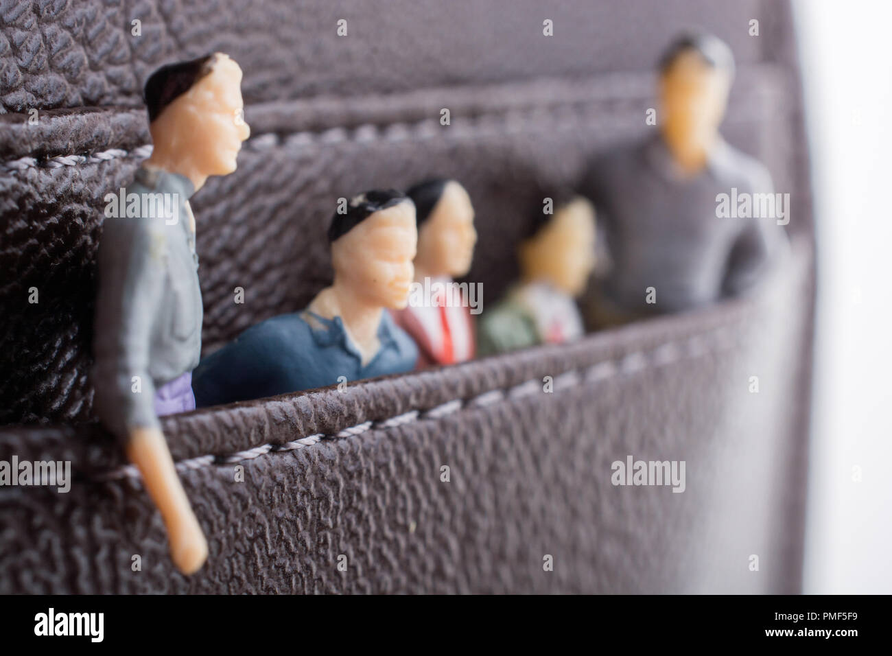 Tiny figurine of group of men miniature model in pockets Stock Photo ...