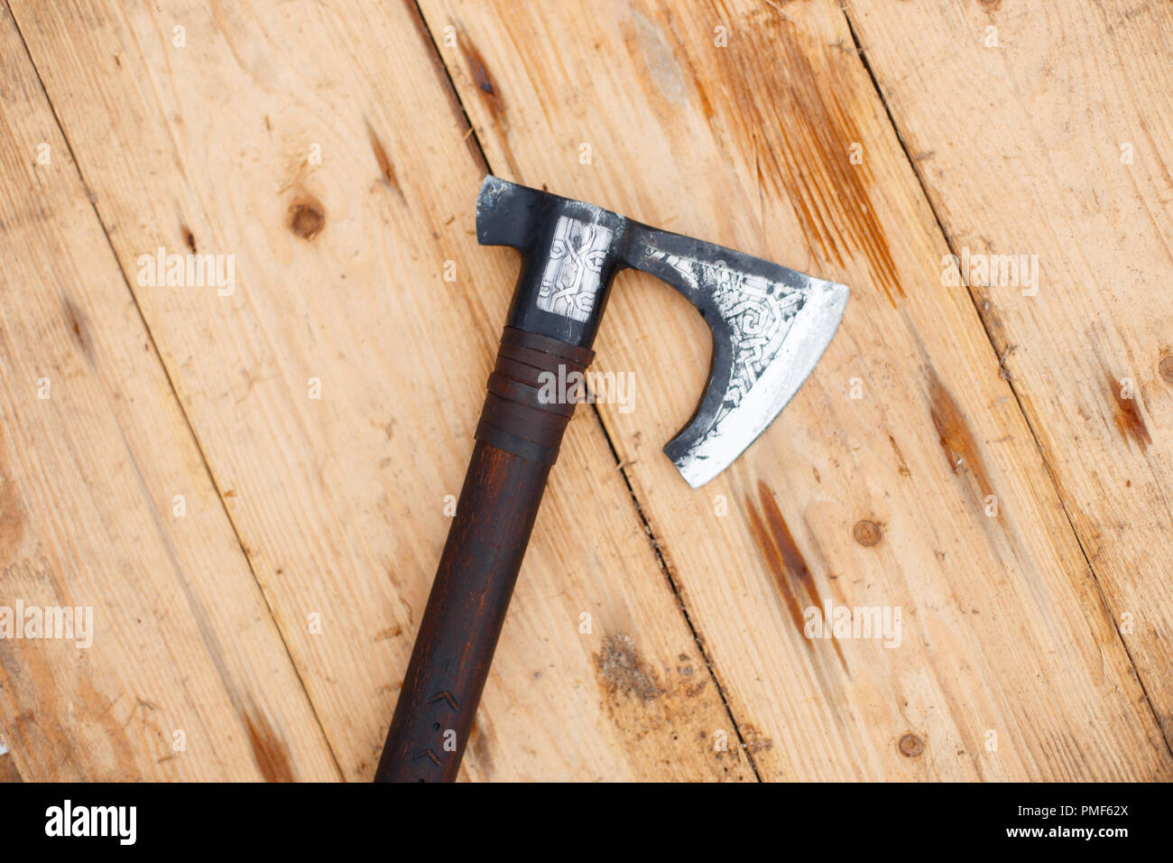 Battle ax of the Vikings lies on a wooden shield Stock Photo - Alamy