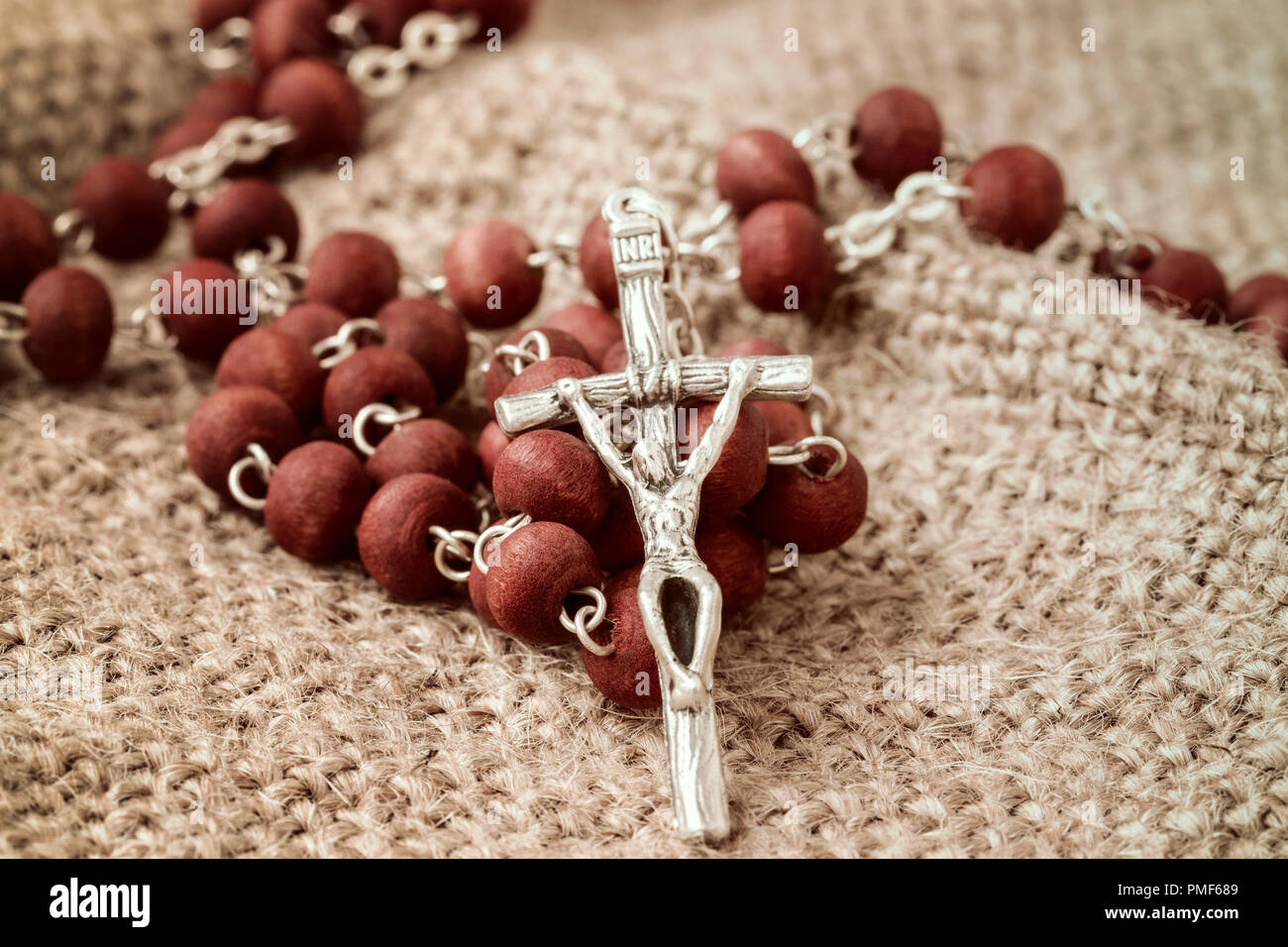 Close-up of christian rosary on old fabric background Stock Photo - Alamy