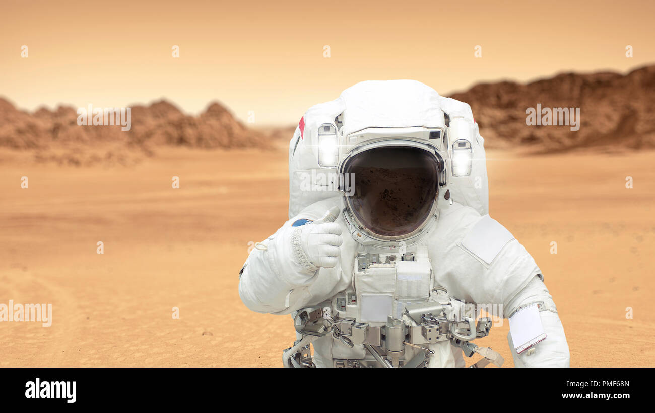 Humans on the planet Mars. Astronaut on Mars shows a thumbs-up ...