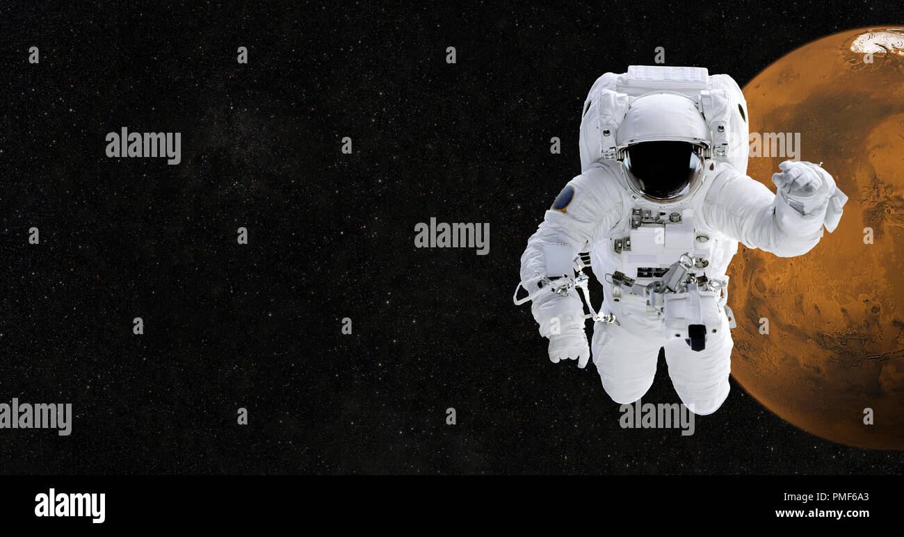 Spaceman travels to Mars. Astronaut in space against the background of ...