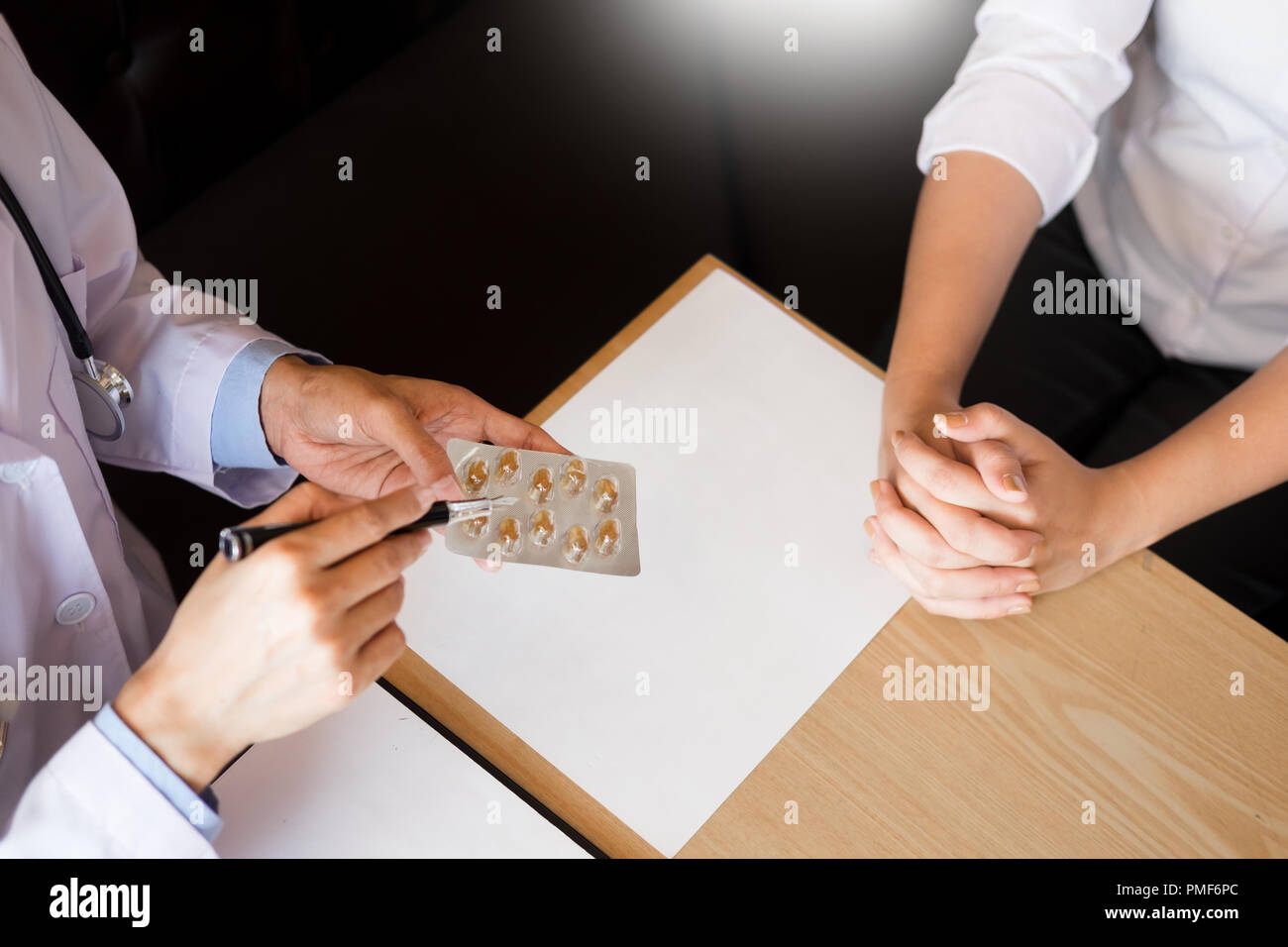 doctor hand holding tablet of drug and explain to patient in hospital ...