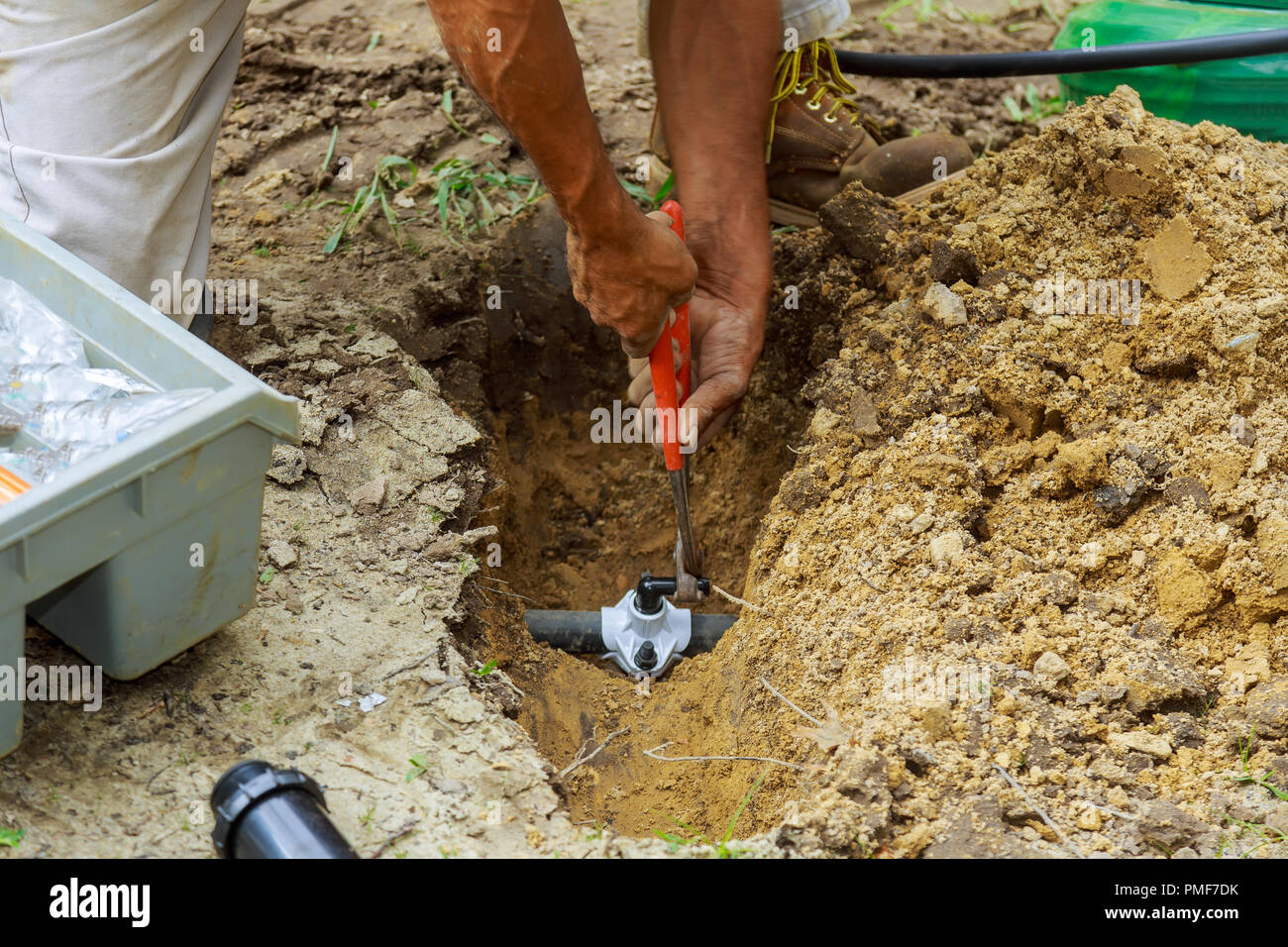 Underground Sprinkler System to Water the Yard Man Working with Pipes ...